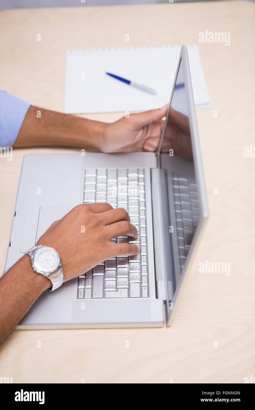Hands using laptop at desk Stock Photo - Alamy