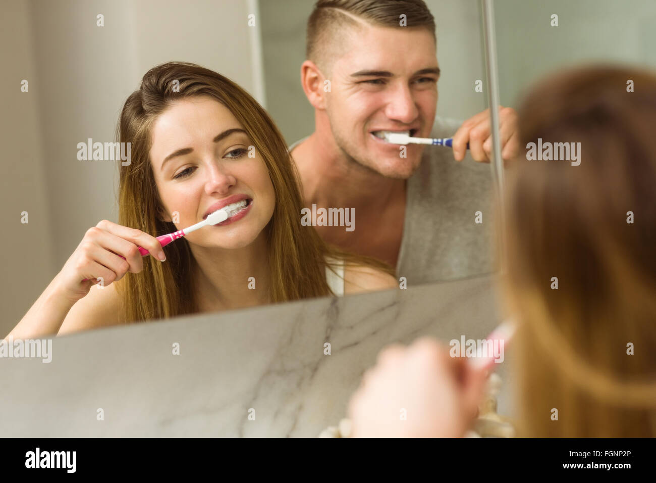 Cute couple brushing their teeth Stock Photo - Alamy