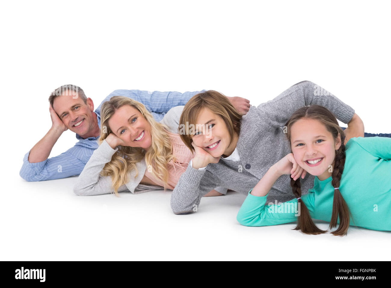 Smiling family lying on the floor in row Stock Photo - Alamy
