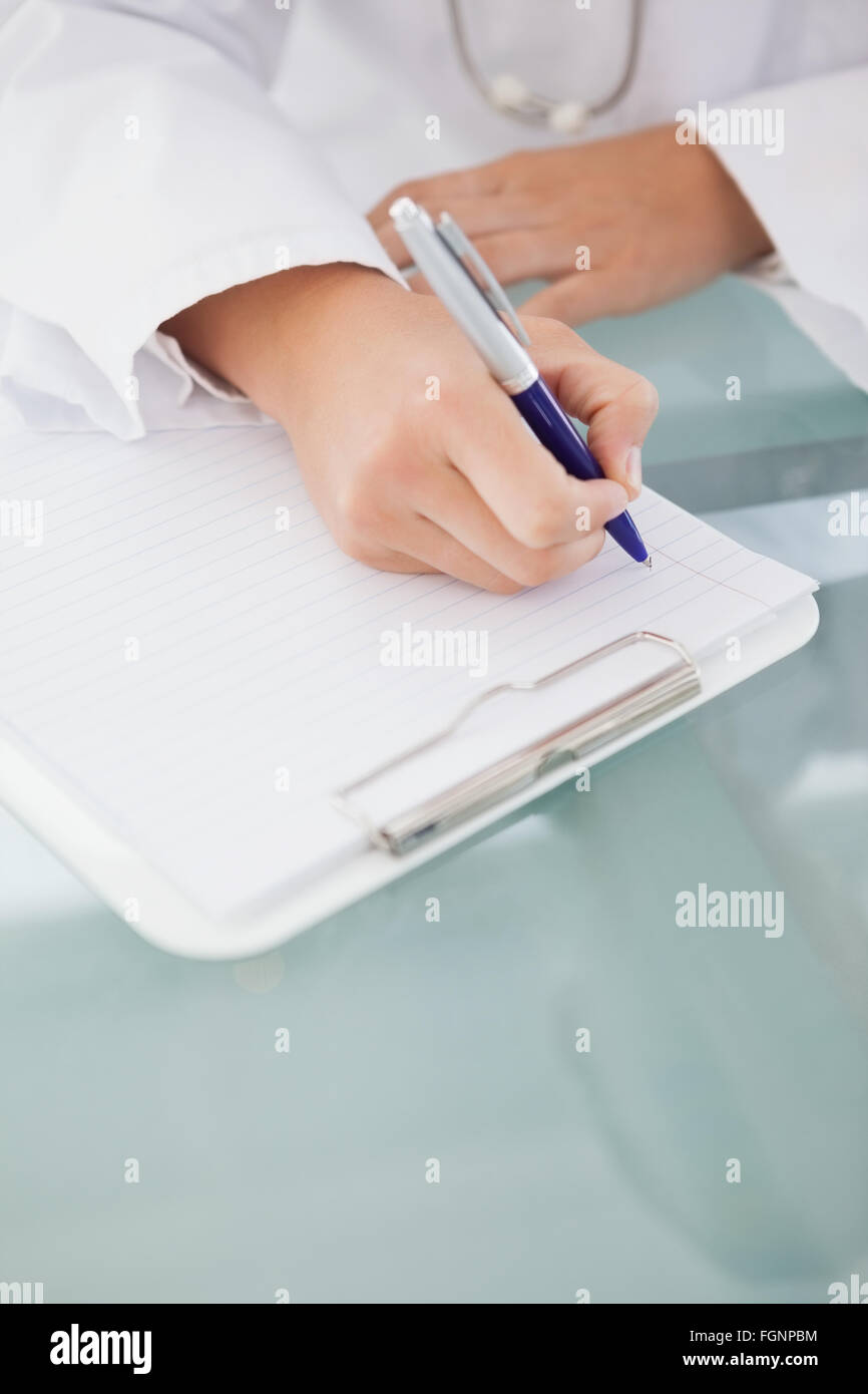 Doctor writing down work notes Stock Photo - Alamy