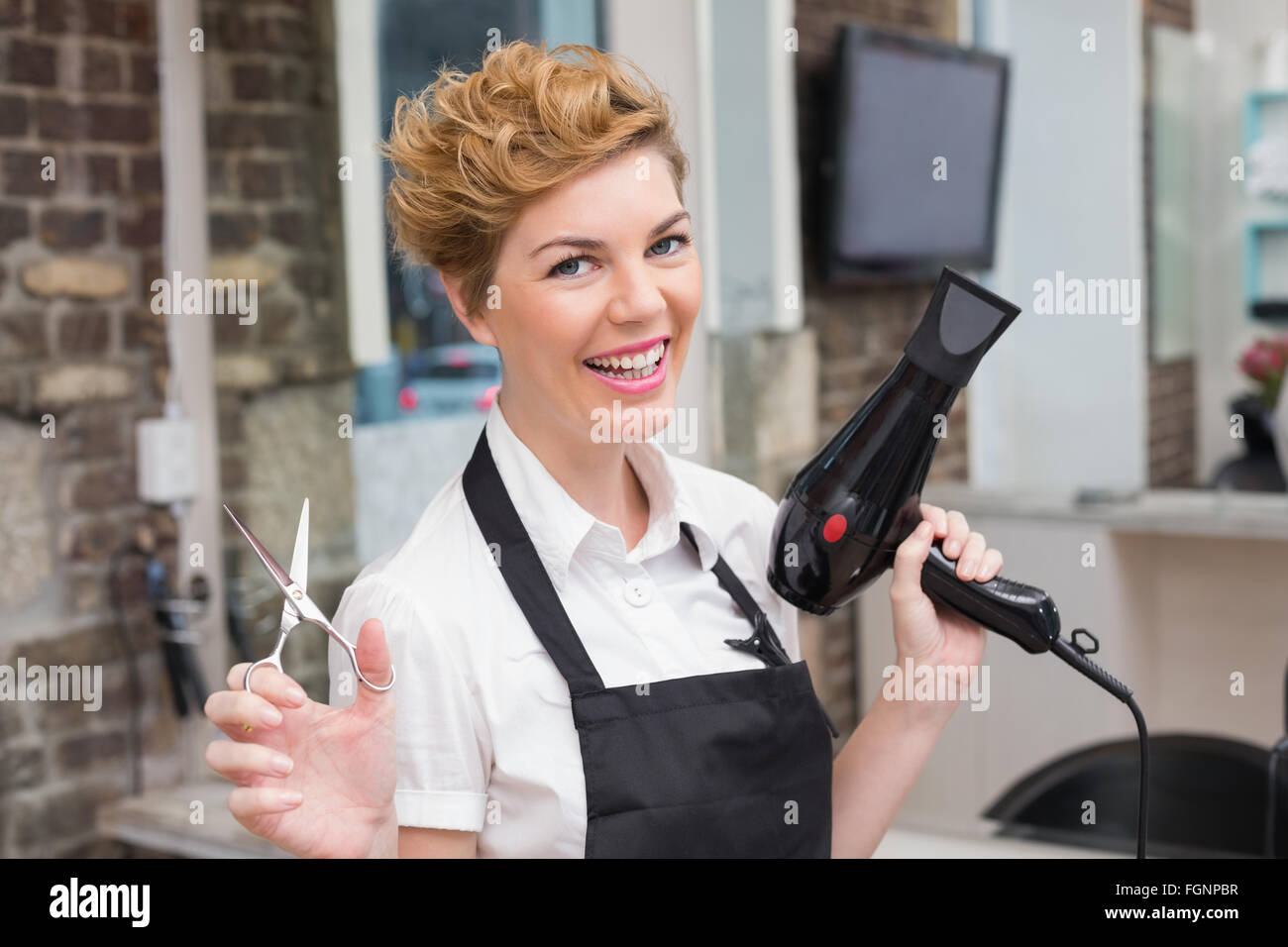 Confident hairdresser smiling at camera Stock Photo - Alamy