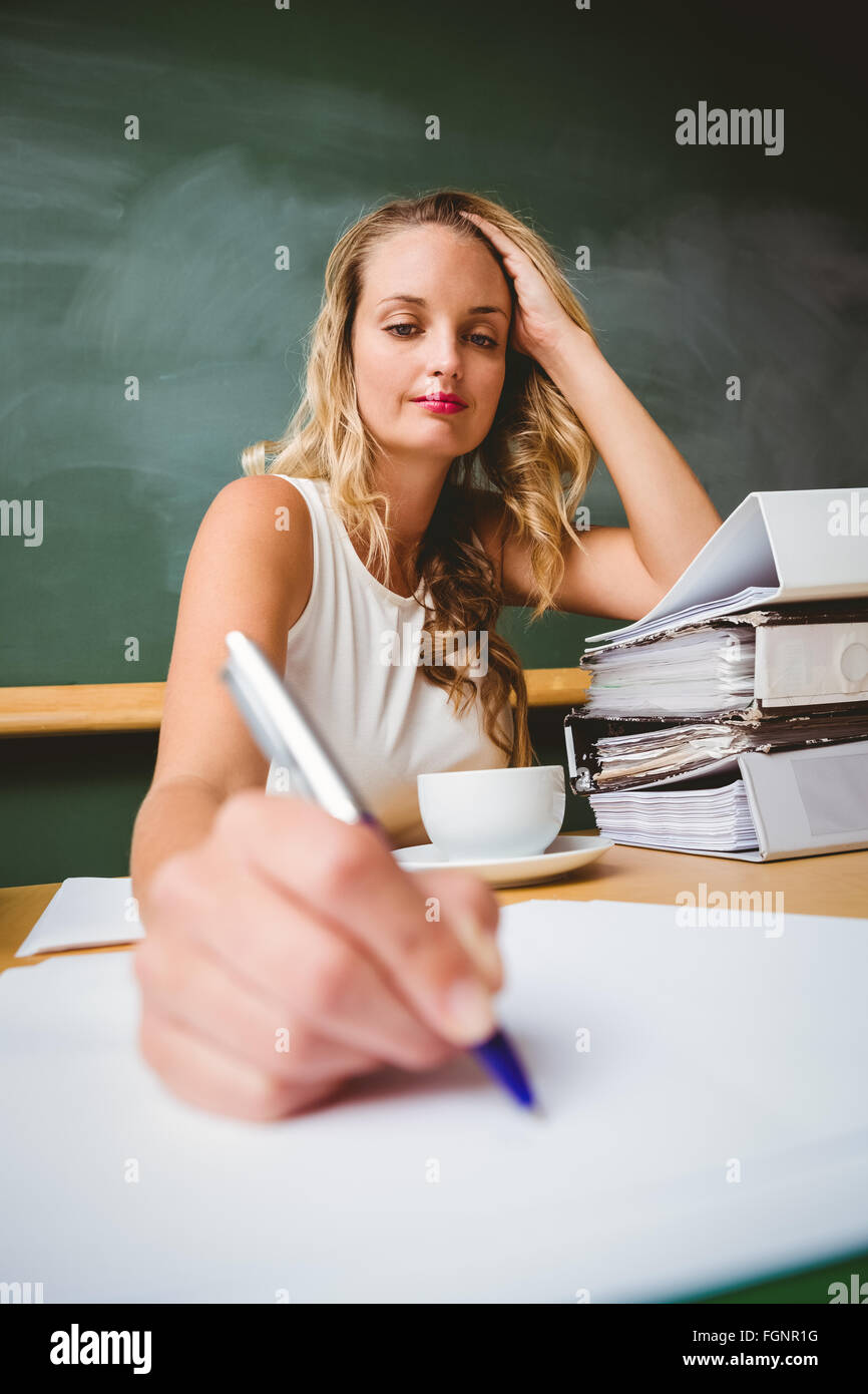 Beautiful businesswoman writing document at desk Stock Photo - Alamy