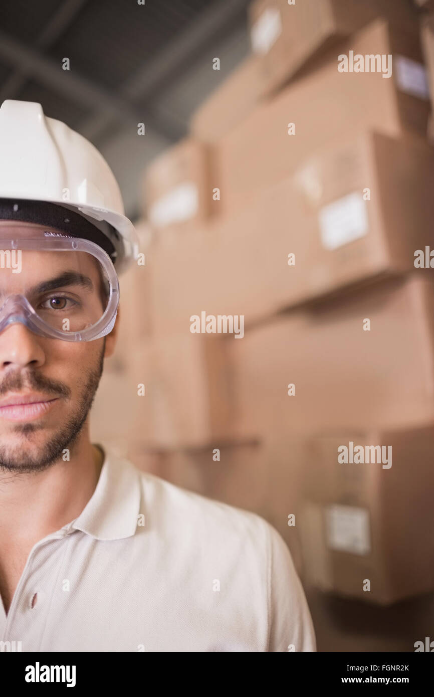 Close up of worker wearing hard hat in warehouse Stock Photo - Alamy