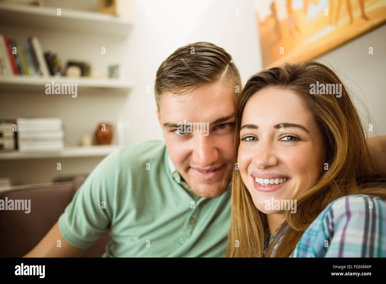 Cute couple relaxing on couch Stock Photo - Alamy