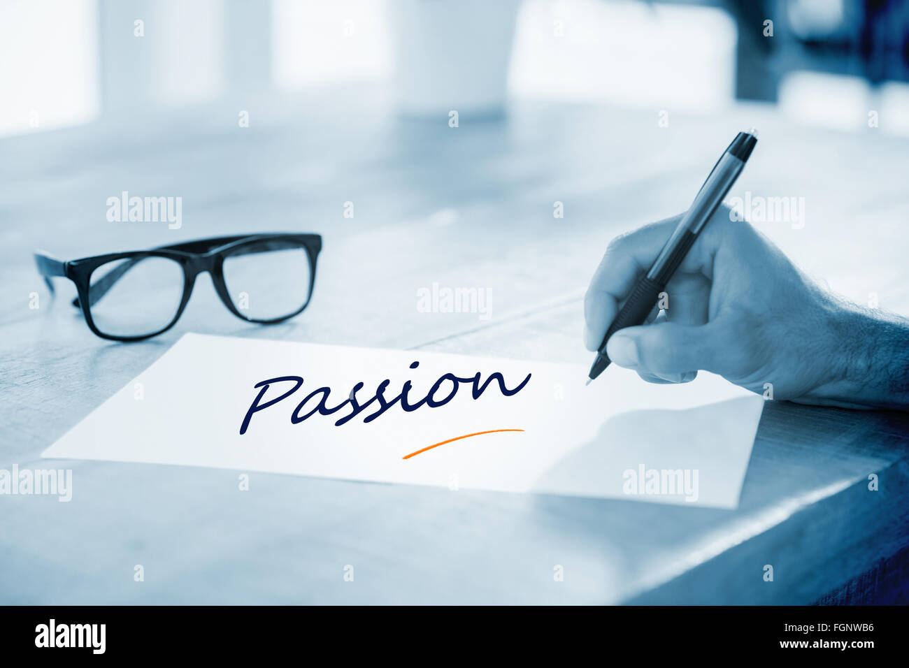 Passion against side view of hand writing on white page on working desk ...