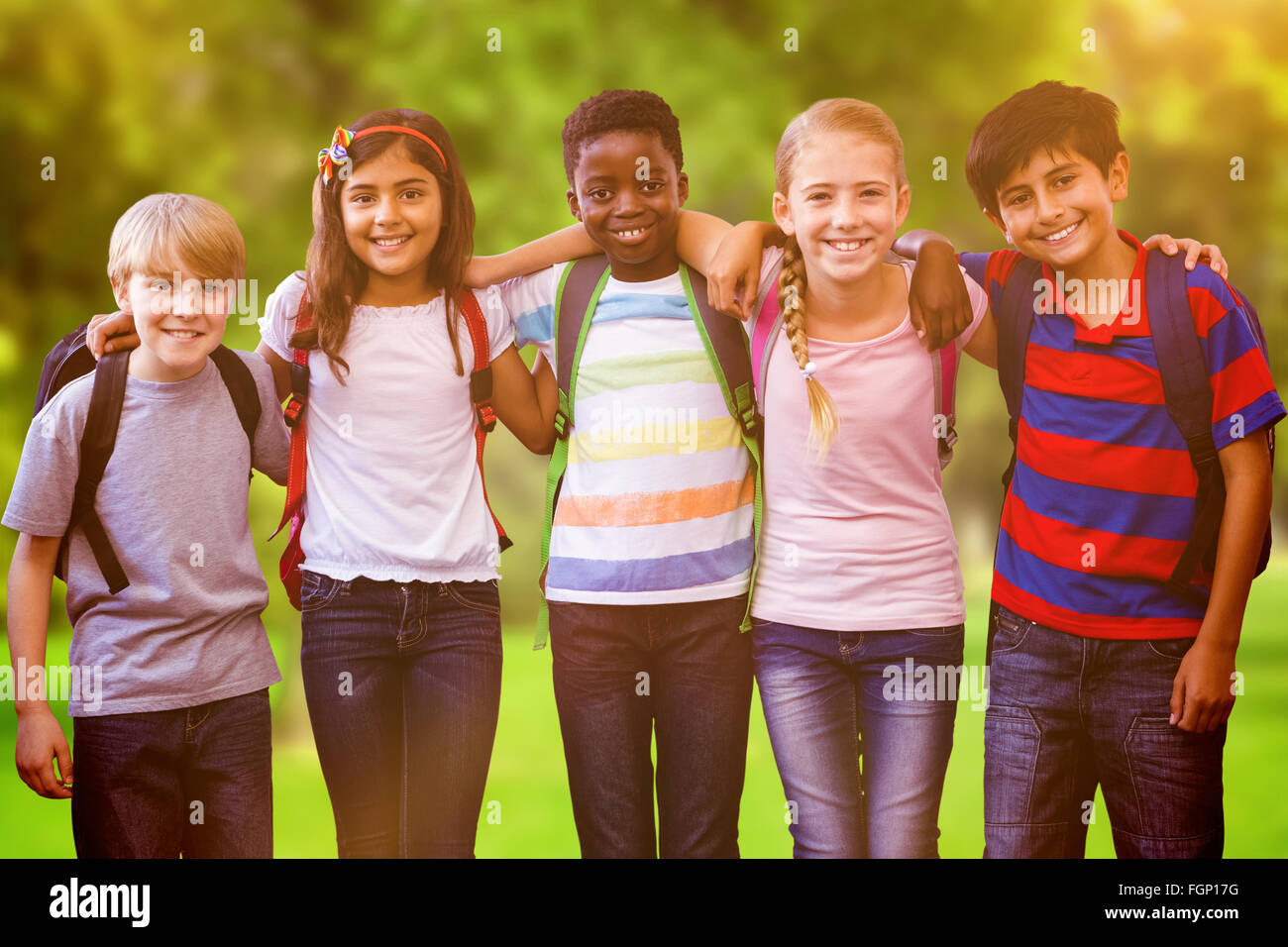 Composite image of smiling little school kids in school corridor Stock ...