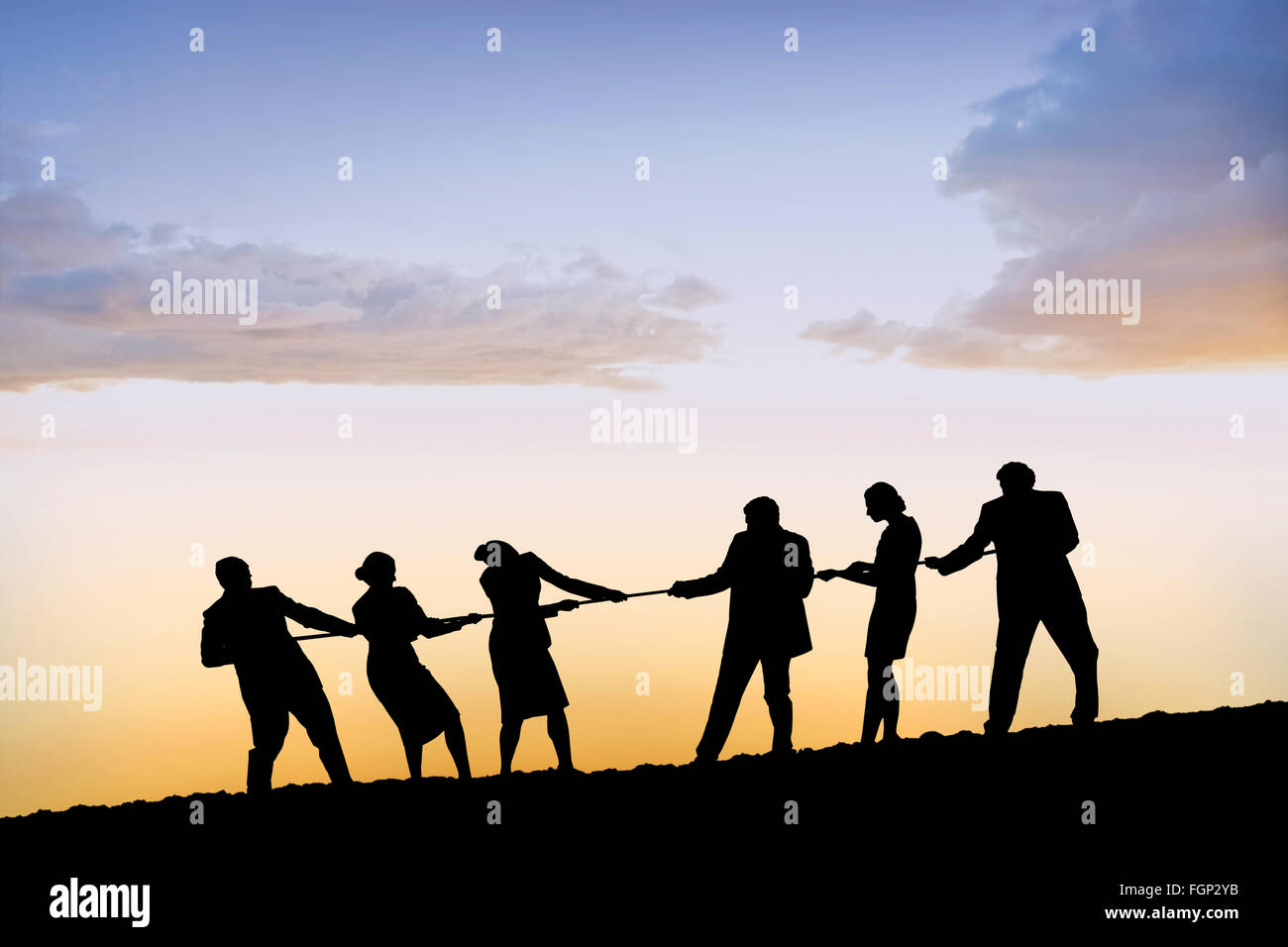 Composite image of silhouettes pulling rope Stock Photo - Alamy