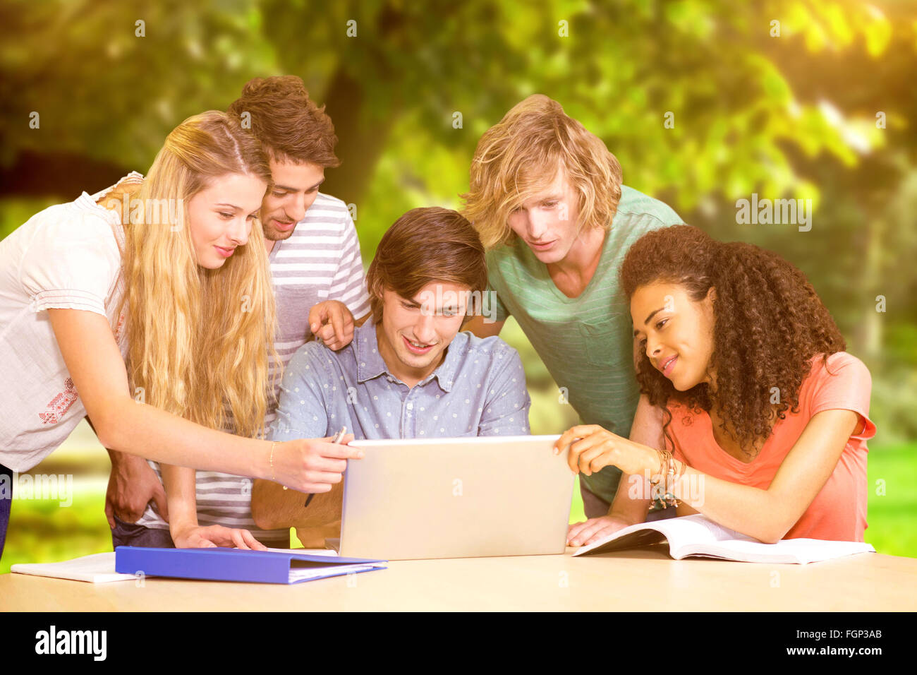 Composite image of college students using laptop in library Stock Photo ...