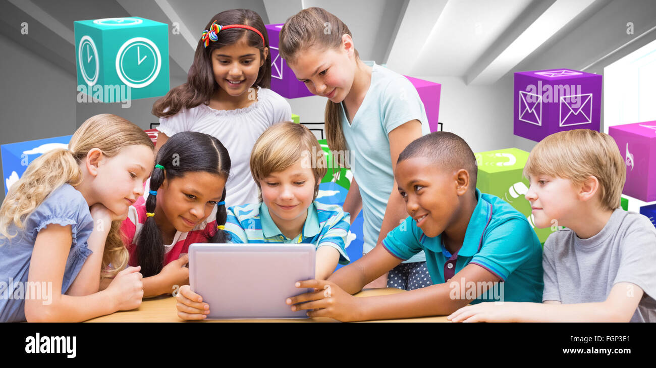 Composite image of cute pupils using tablet computer in library Stock ...