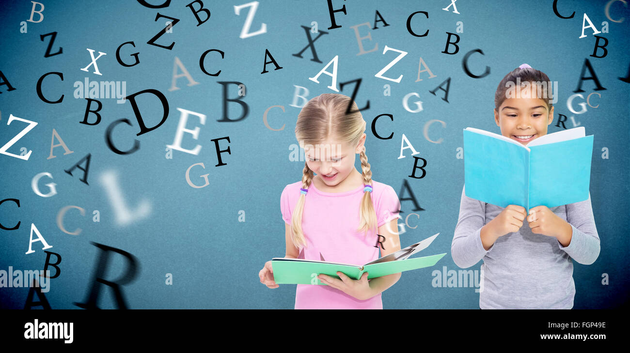 Composite image of elementary pupils reading Stock Photo - Alamy
