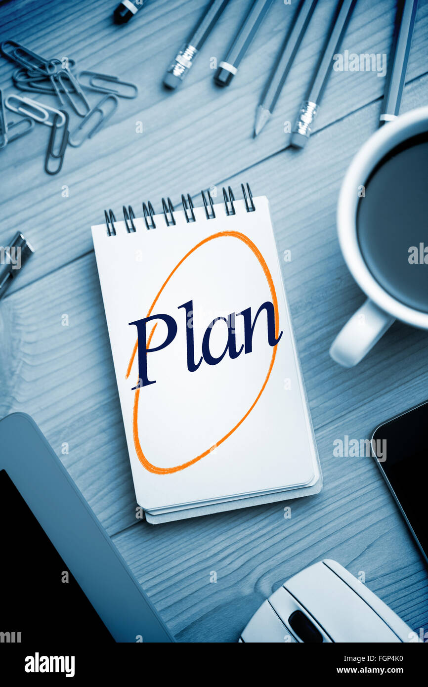 Plan against notepad on desk Stock Photo - Alamy