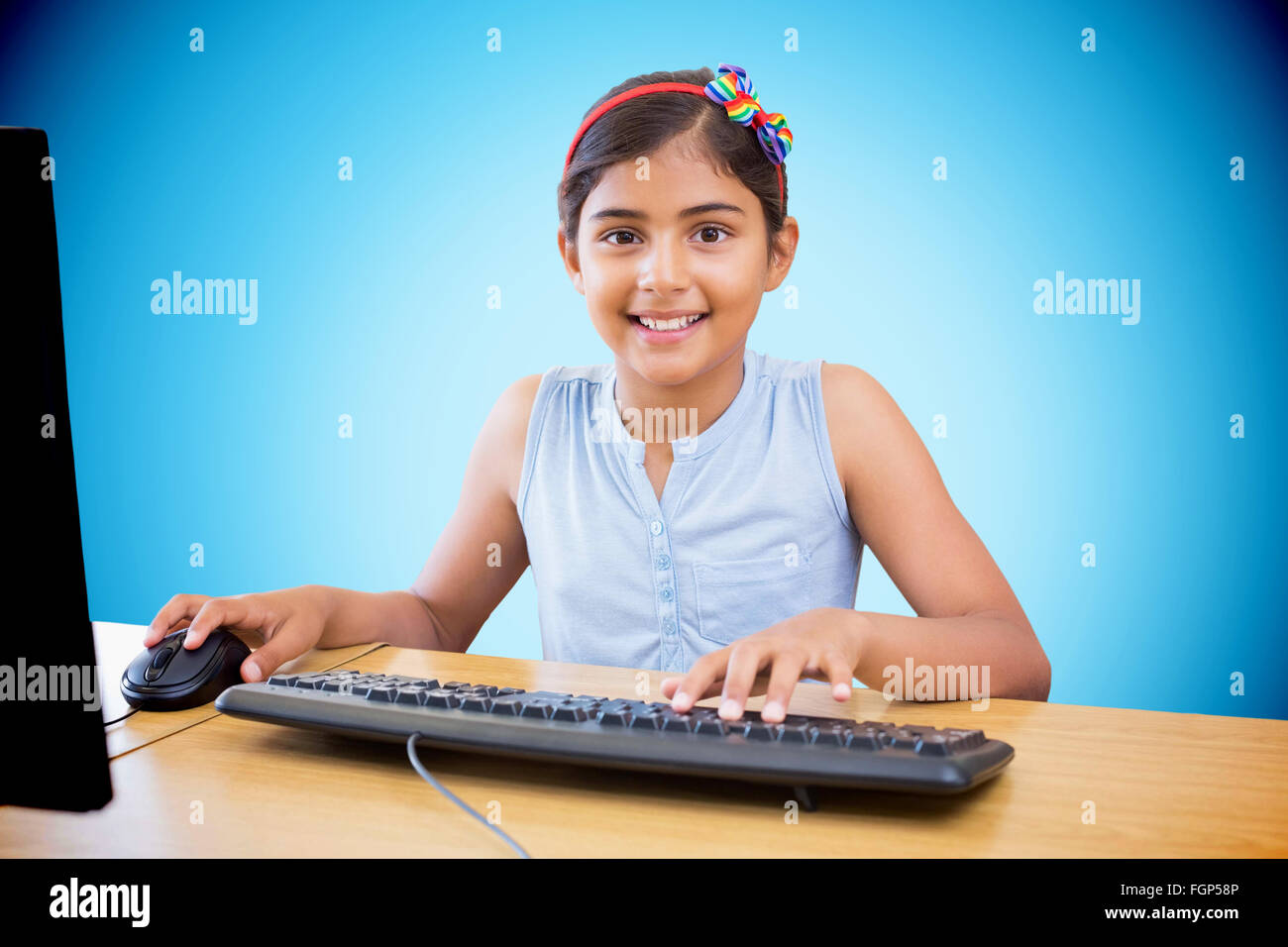 Composite image of school kid on computer Stock Photo - Alamy