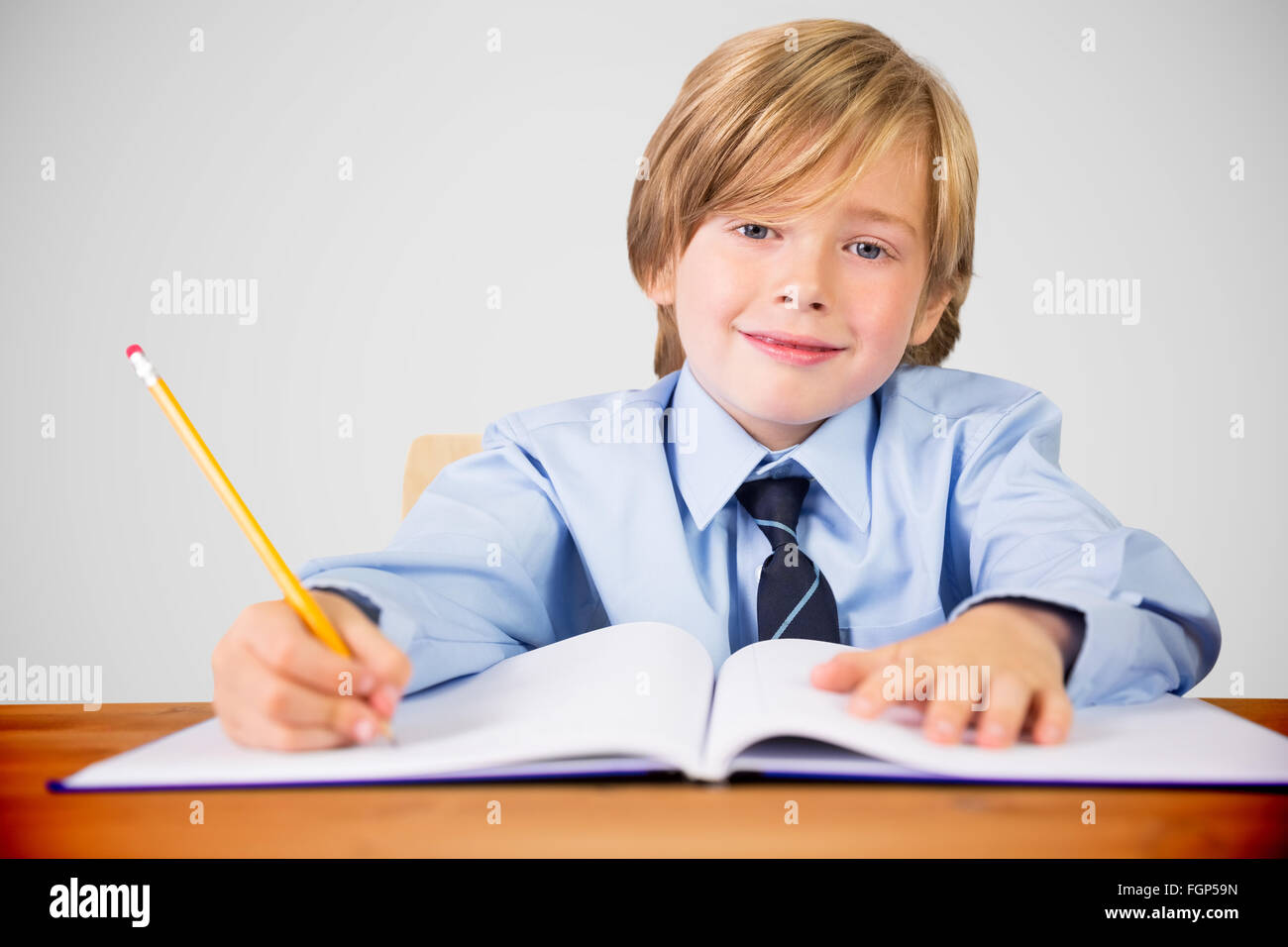 Composite image of cute pupil writing Stock Photo - Alamy