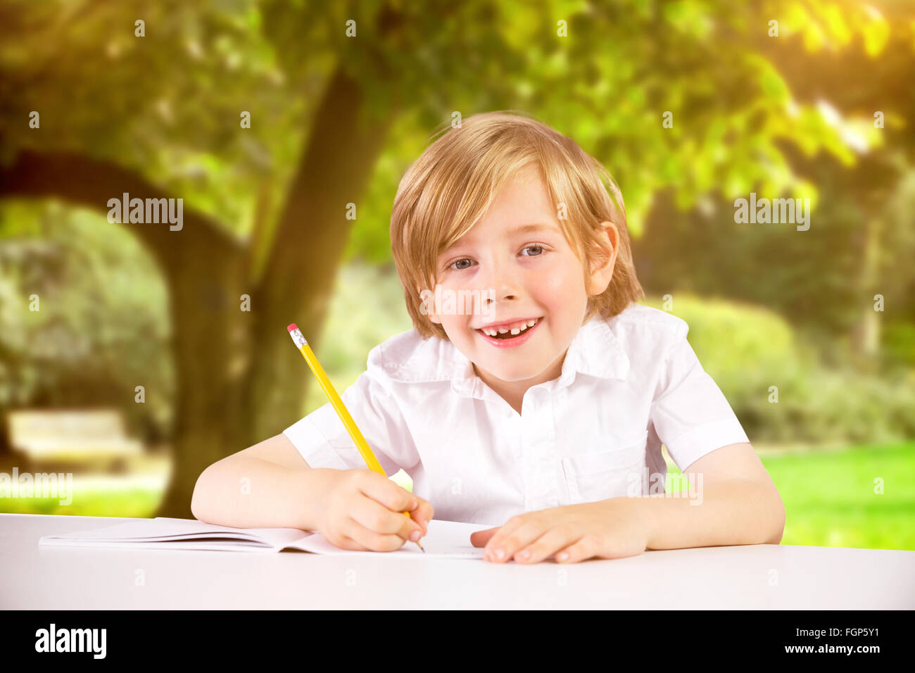 Composite image of cute pupil writing Stock Photo - Alamy