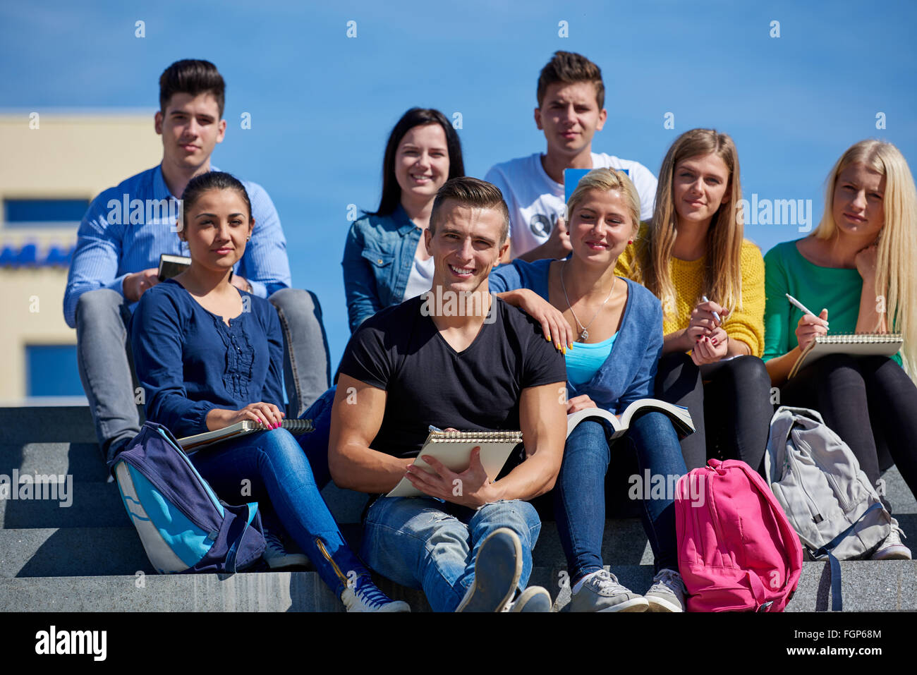 students outside sitting on steps Stock Photo - Alamy