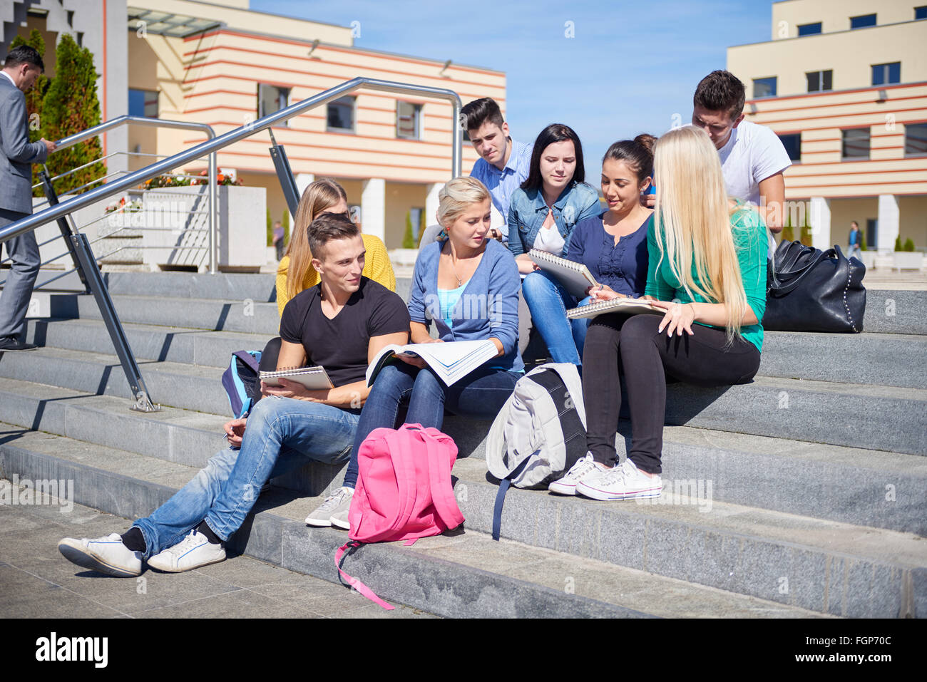 students outside sitting on steps Stock Photo - Alamy