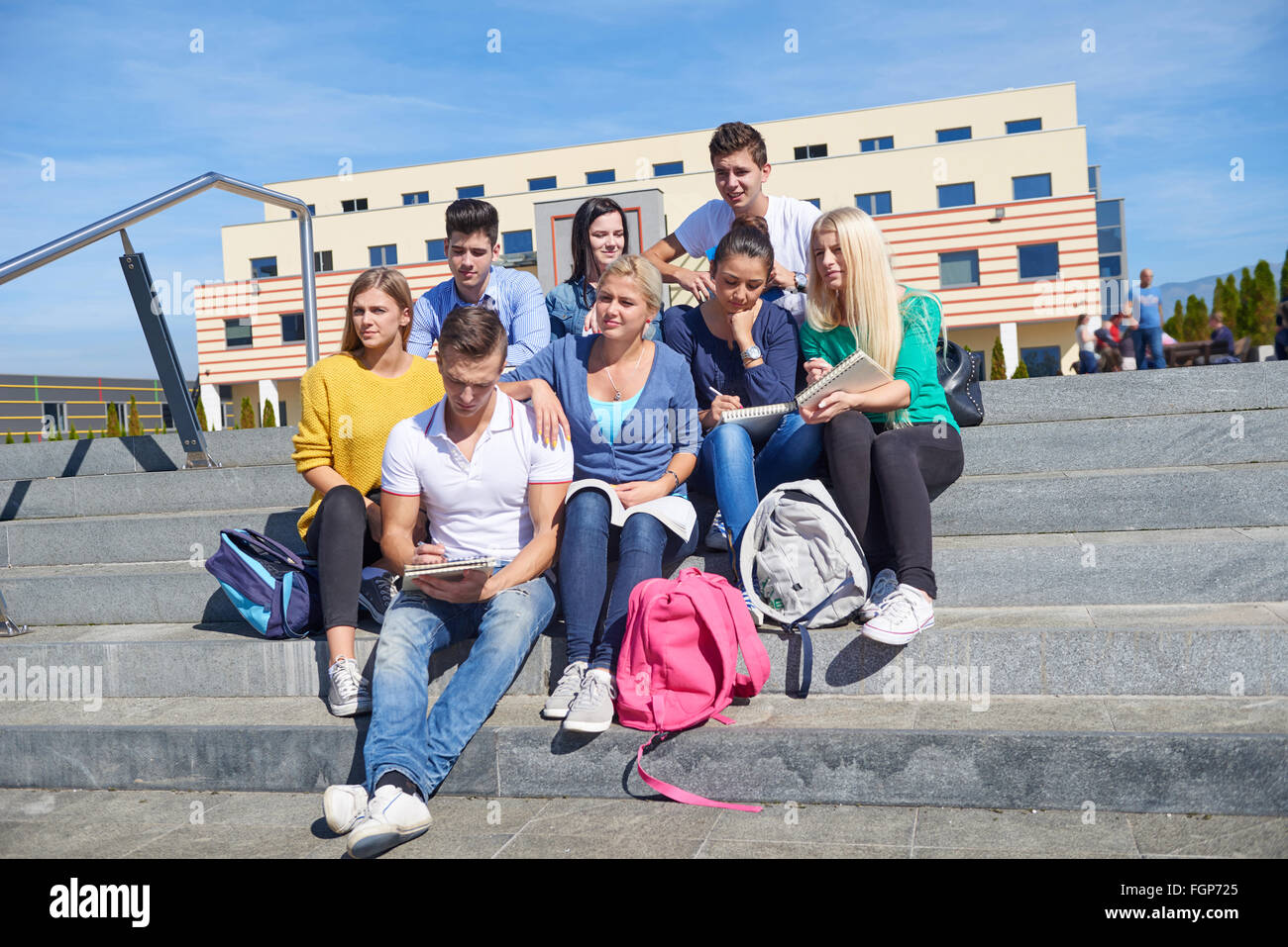 students outside sitting on steps Stock Photo - Alamy