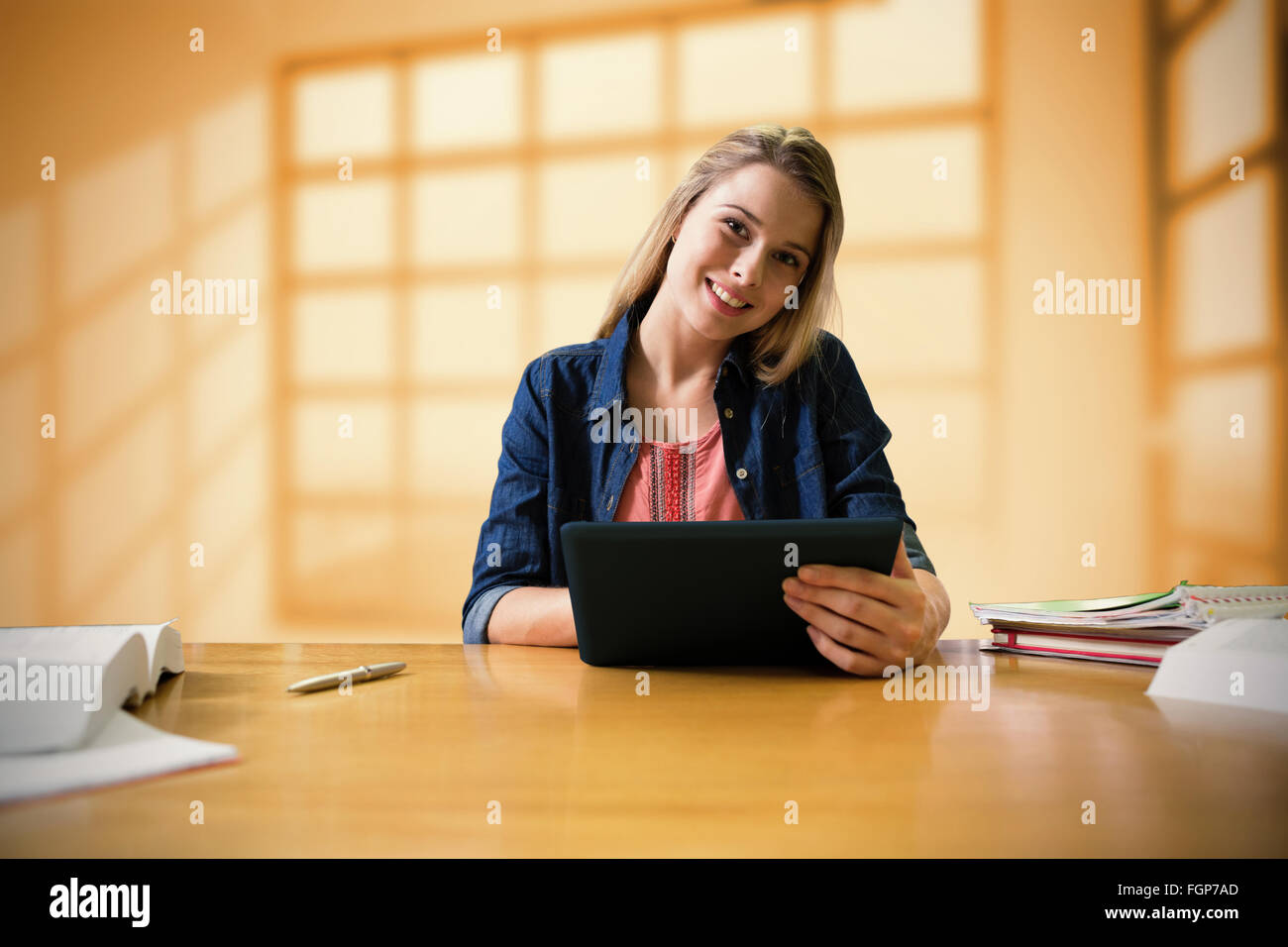 Composite image of student studying in the library with tablet Stock ...