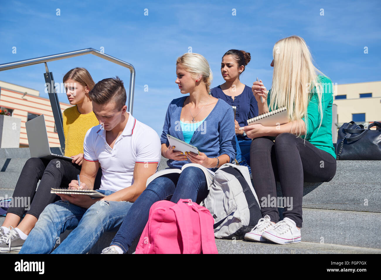 students outside sitting on steps Stock Photo - Alamy
