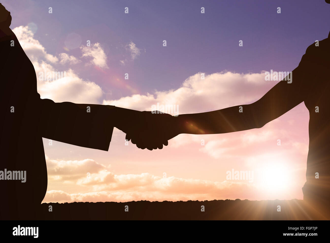 Composite image of silhouettes shaking hands Stock Photo - Alamy