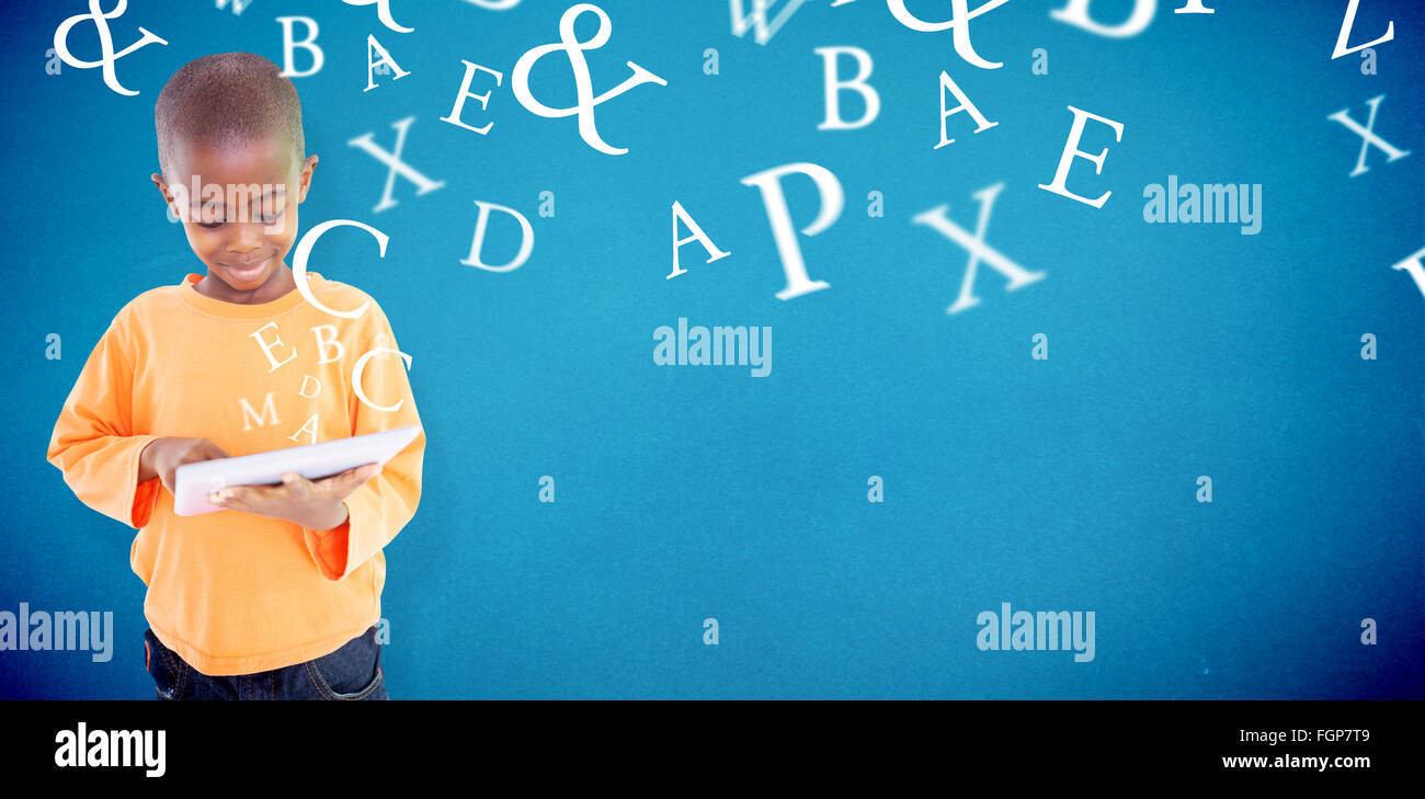 Composite image of cute boy using his tablet pc Stock Photo - Alamy