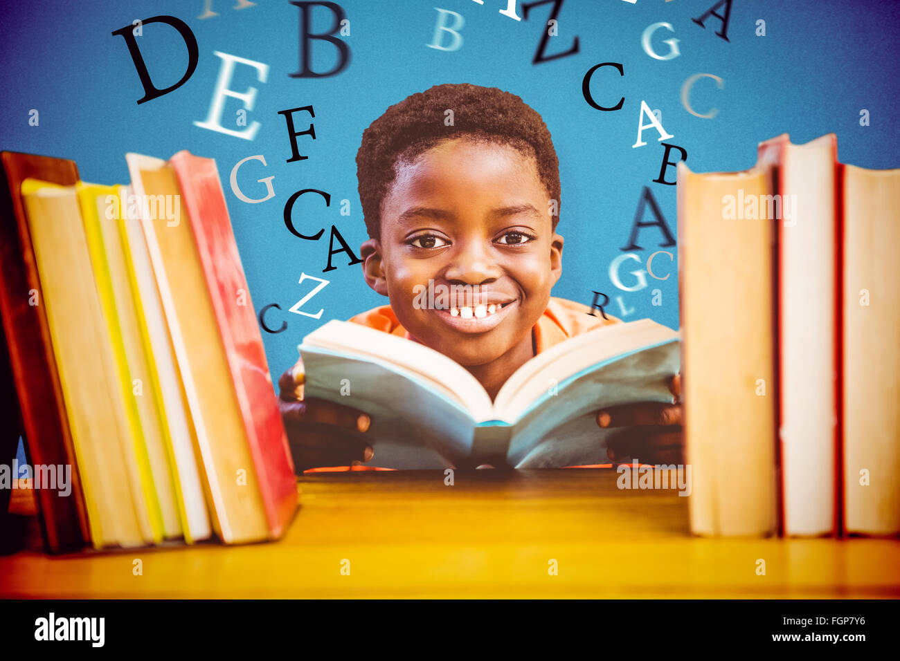 Composite image of cute boy reading book in library Stock Photo - Alamy