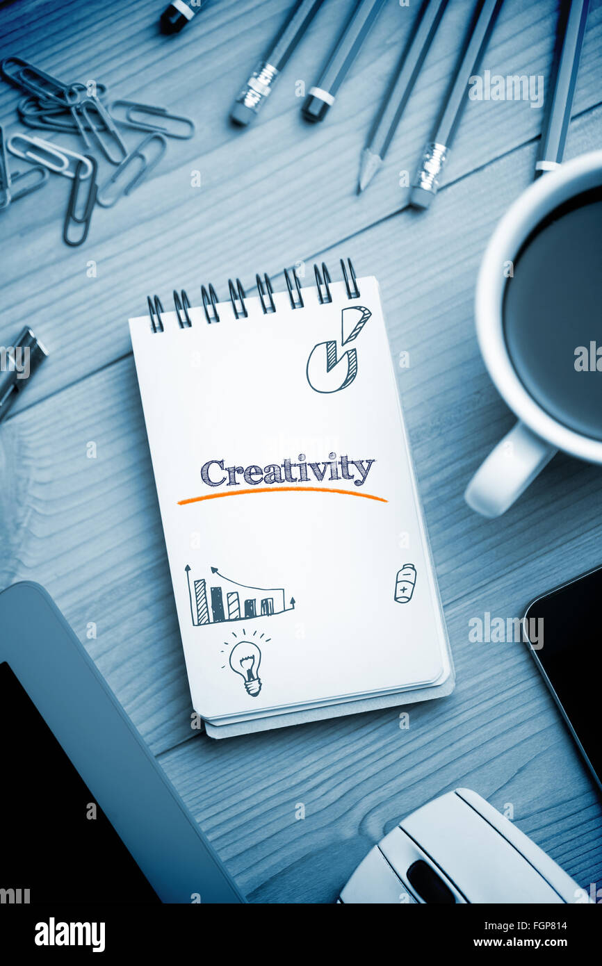 Creativity against notepad on desk Stock Photo - Alamy