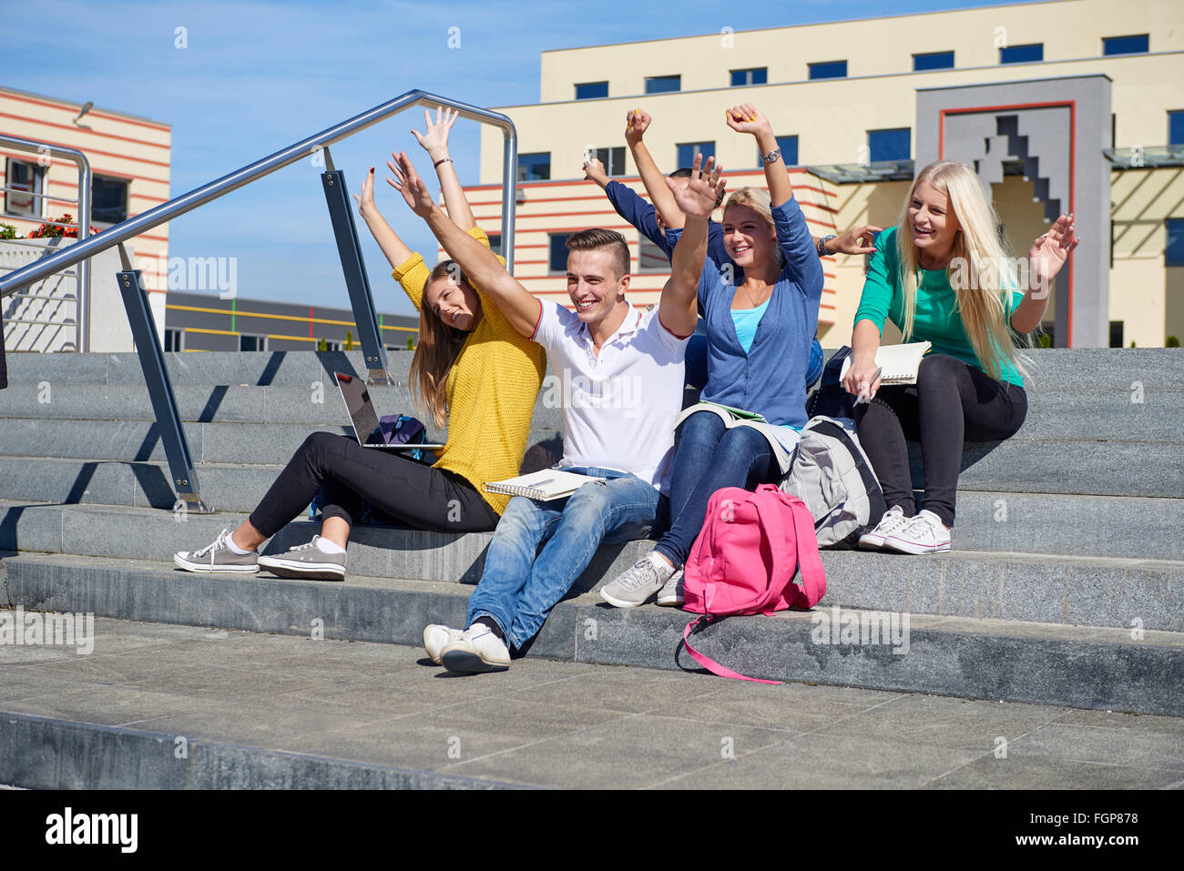 students outside sitting on steps Stock Photo - Alamy