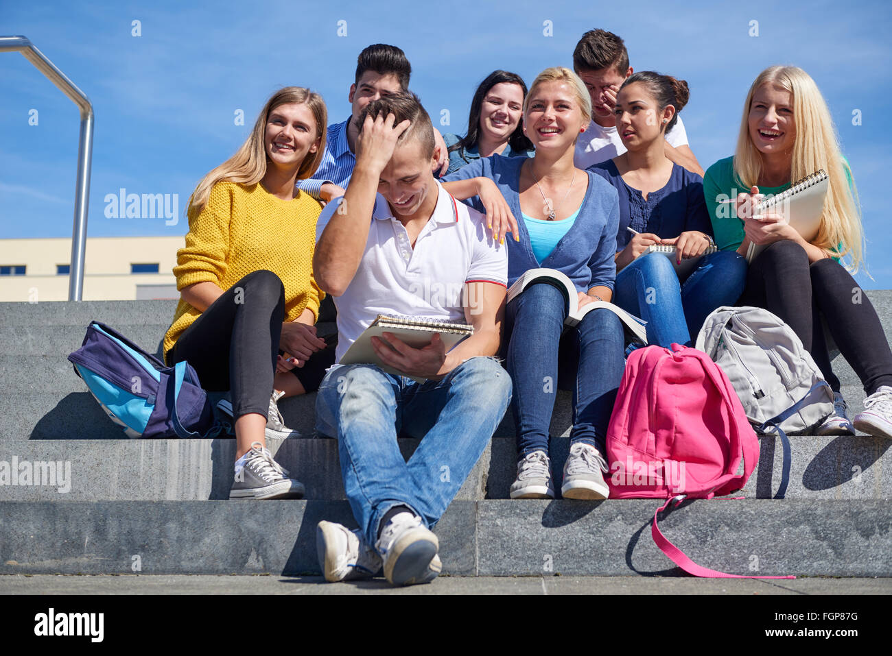 students outside sitting on steps Stock Photo - Alamy