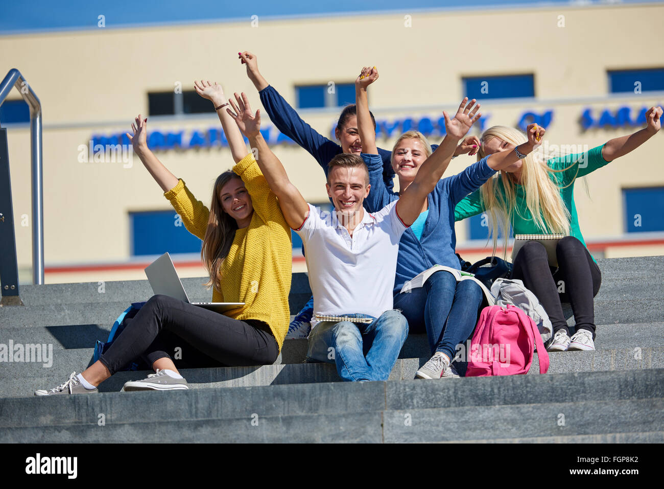 students outside sitting on steps Stock Photo - Alamy