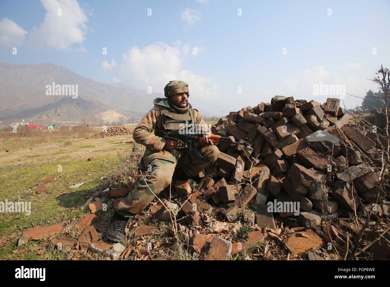 Srinagar. 22nd Feb, 2016. An Indian army soldier takes position near ...