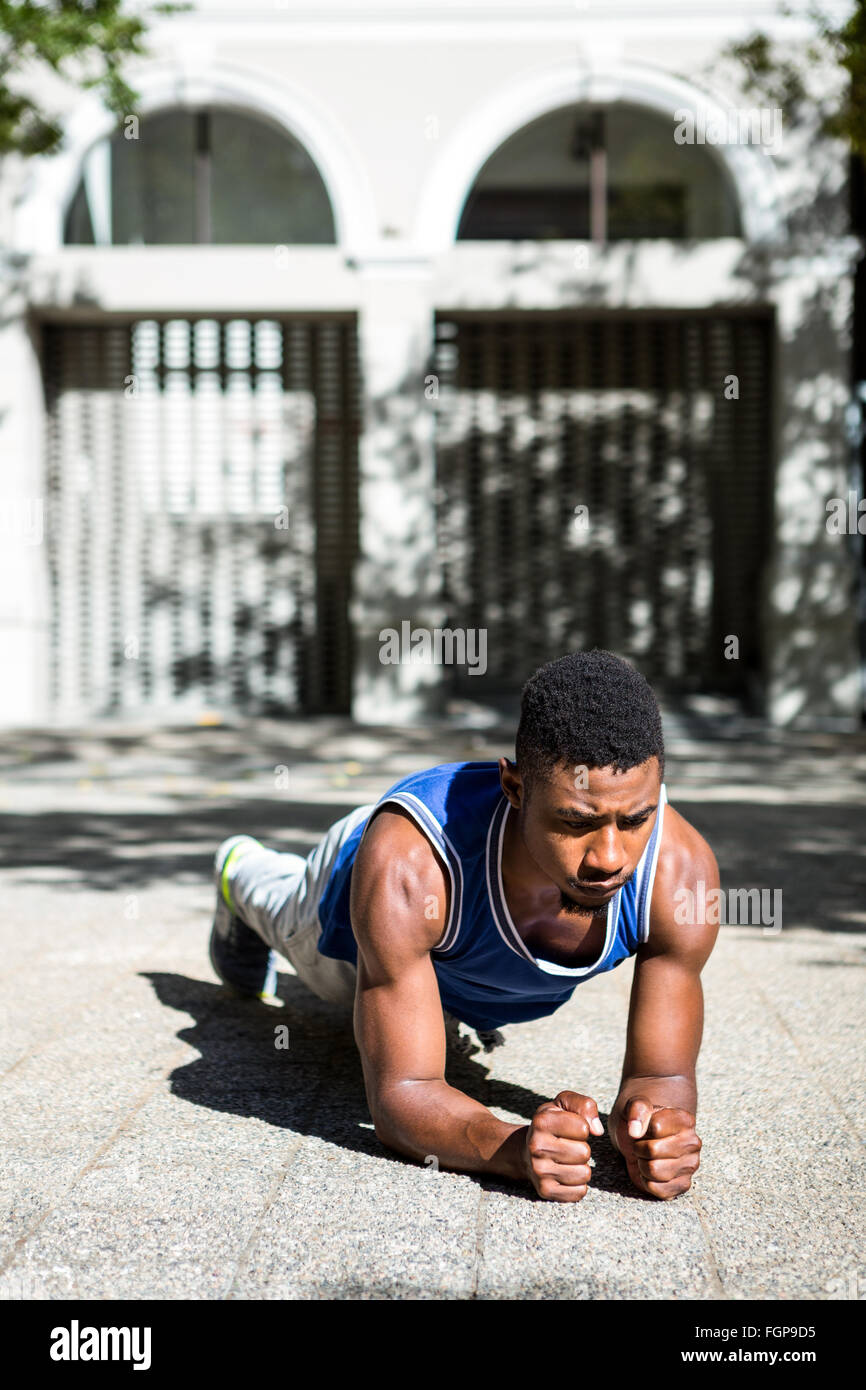 A muscular man on plank position Stock Photo - Alamy