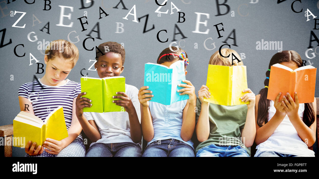 Composite image of children reading books at park Stock Photo - Alamy