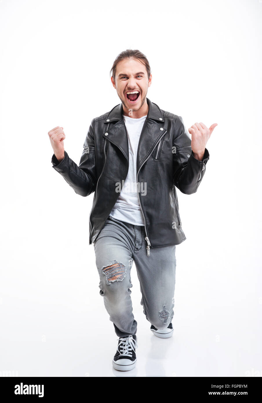 Excited successful young man shouting and celebrating victory over ...