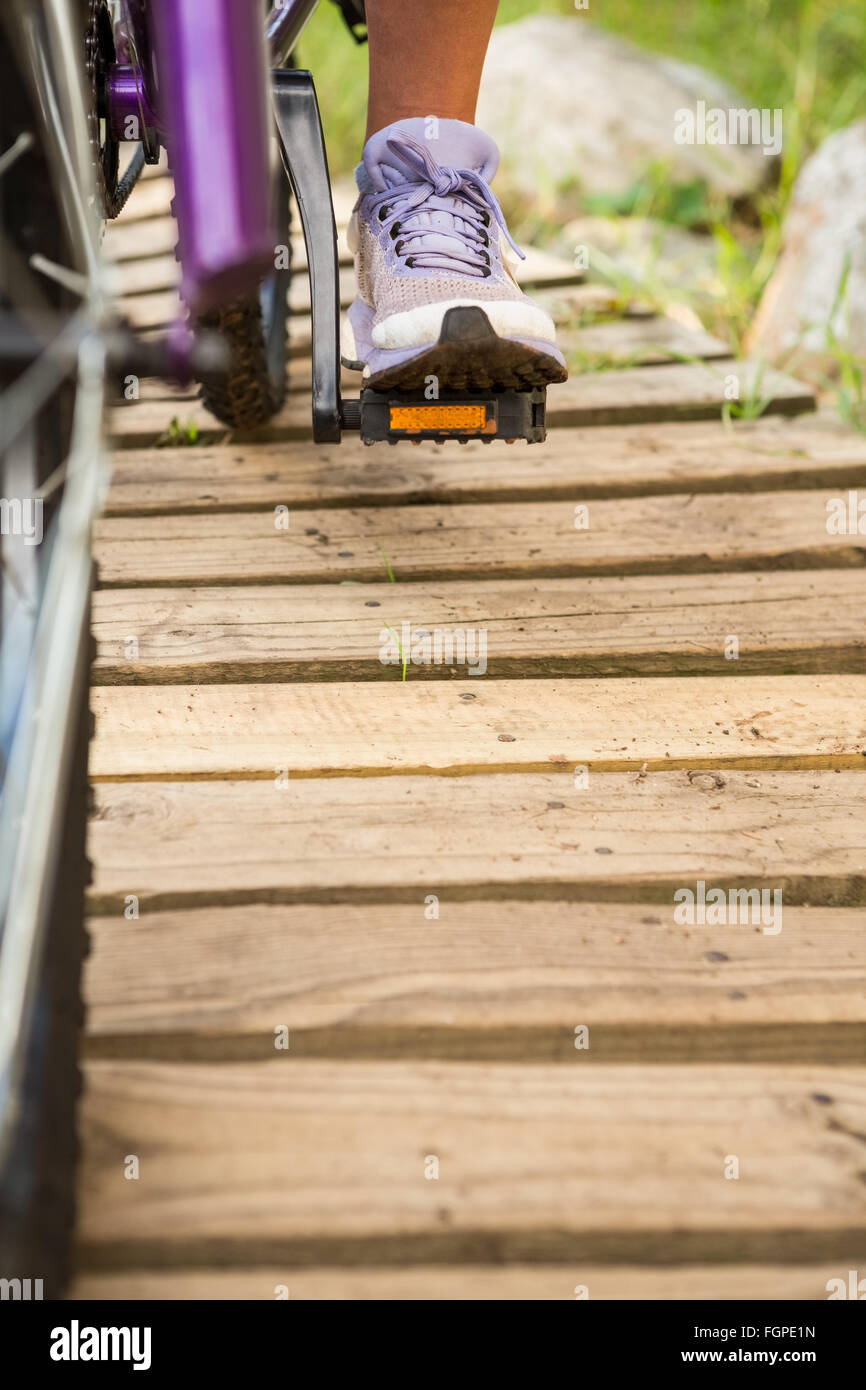 Close up view of woman pedaling on mountain bike Stock Photo - Alamy