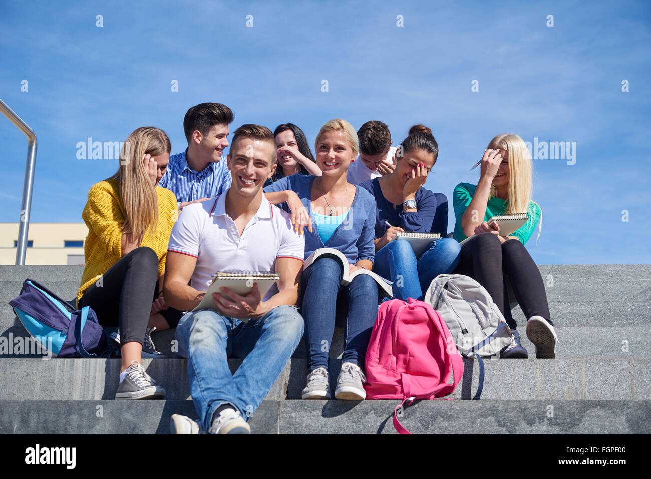 students outside sitting on steps Stock Photo - Alamy
