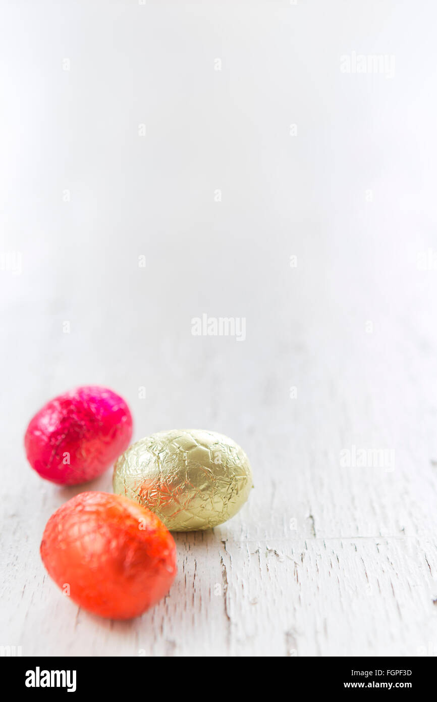 Close up of an assortment of chocolate Easter eggs on a rustic wooden background Stock Photo - Alamy