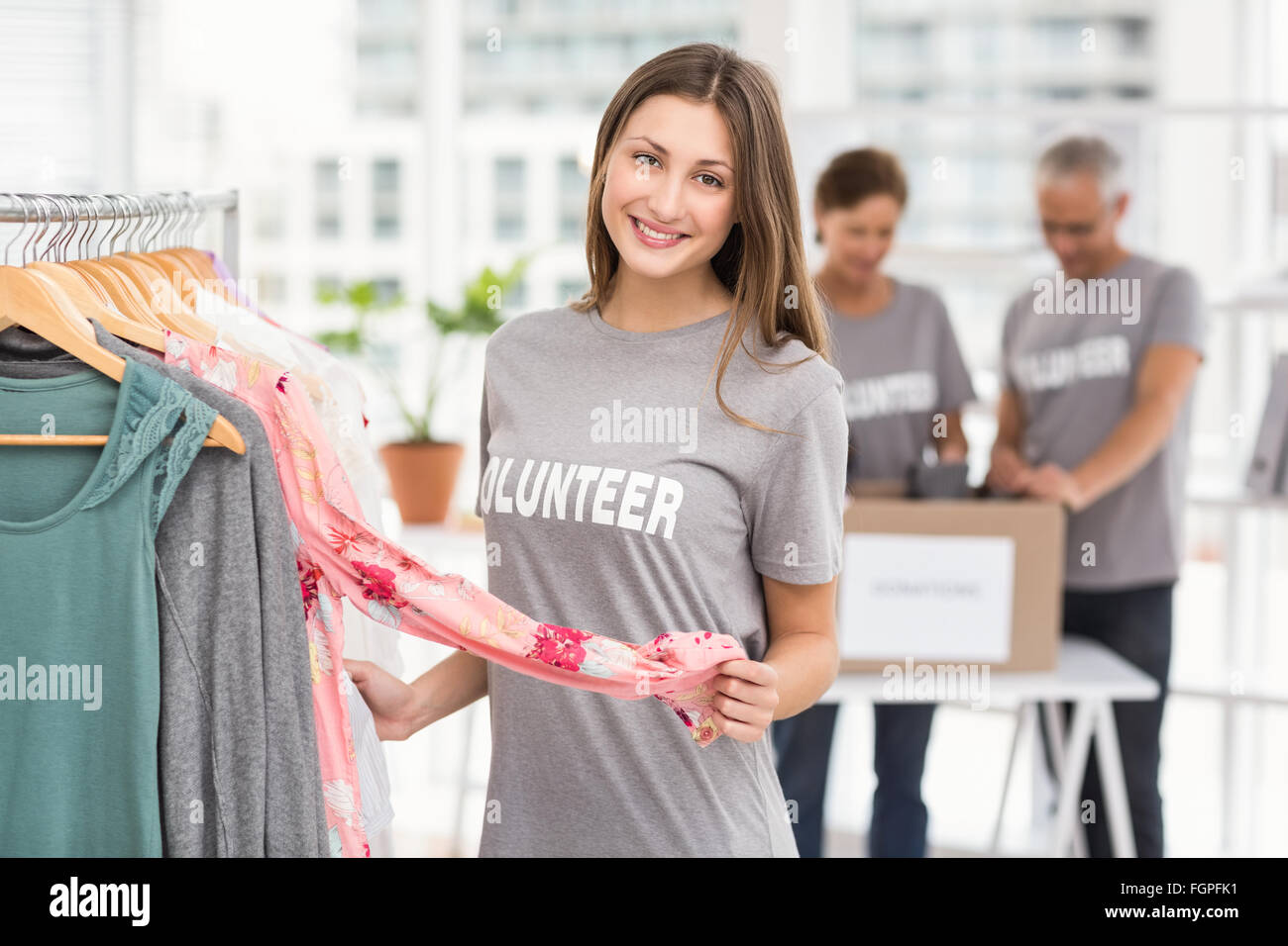 Caucasian female volunteer sorting clothes hi-res stock photography and ...