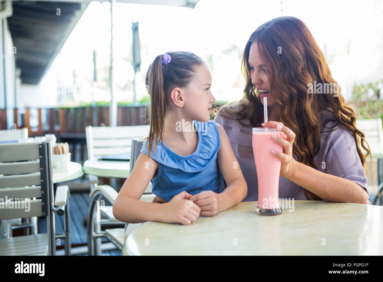 Mother and daughter sitting outside the cafe Stock Photo - Alamy