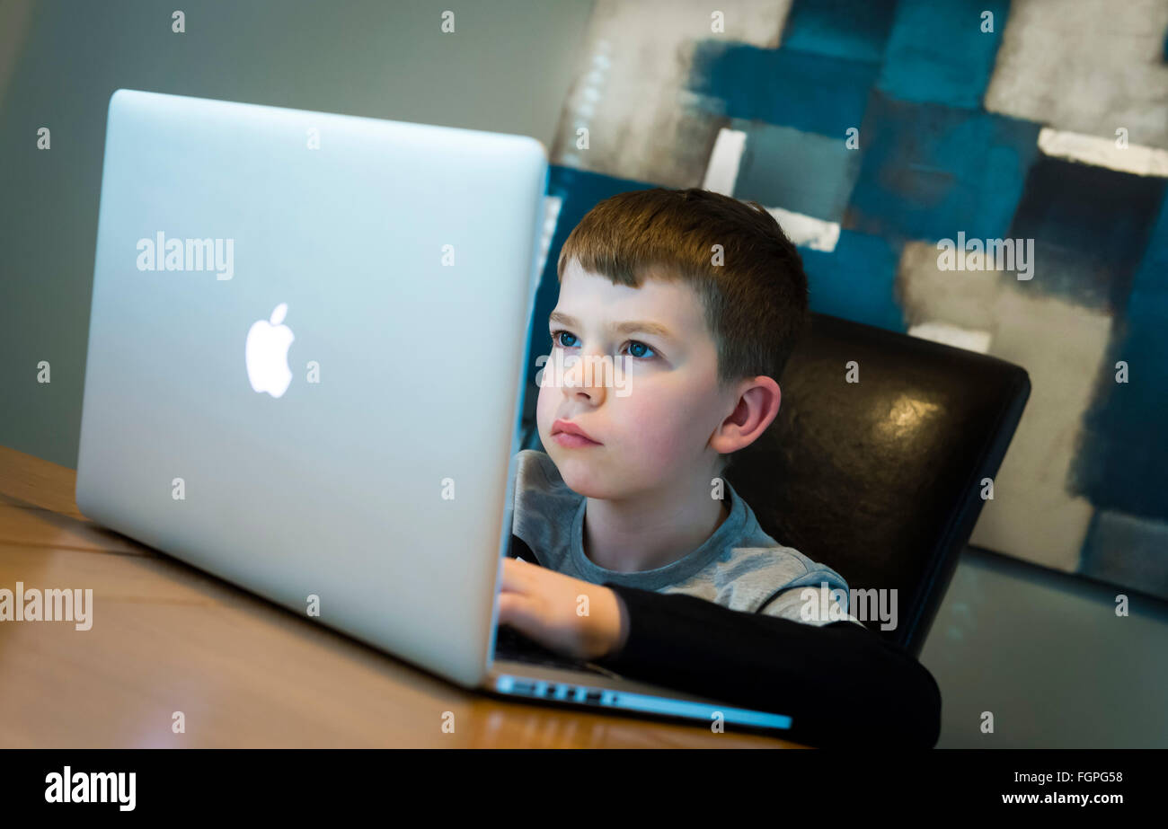 young boy using a computer Stock Photo - Alamy