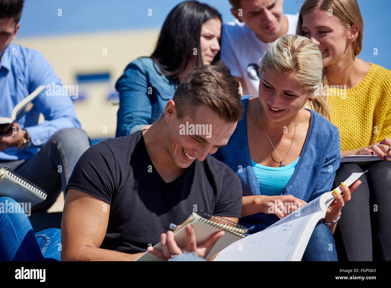 students outside sitting on steps Stock Photo - Alamy