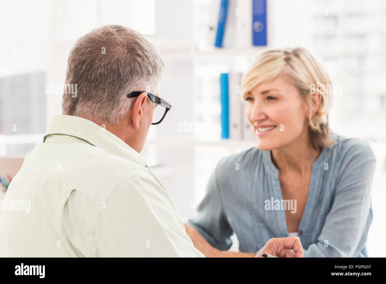 Smiling business team talking together Stock Photo - Alamy
