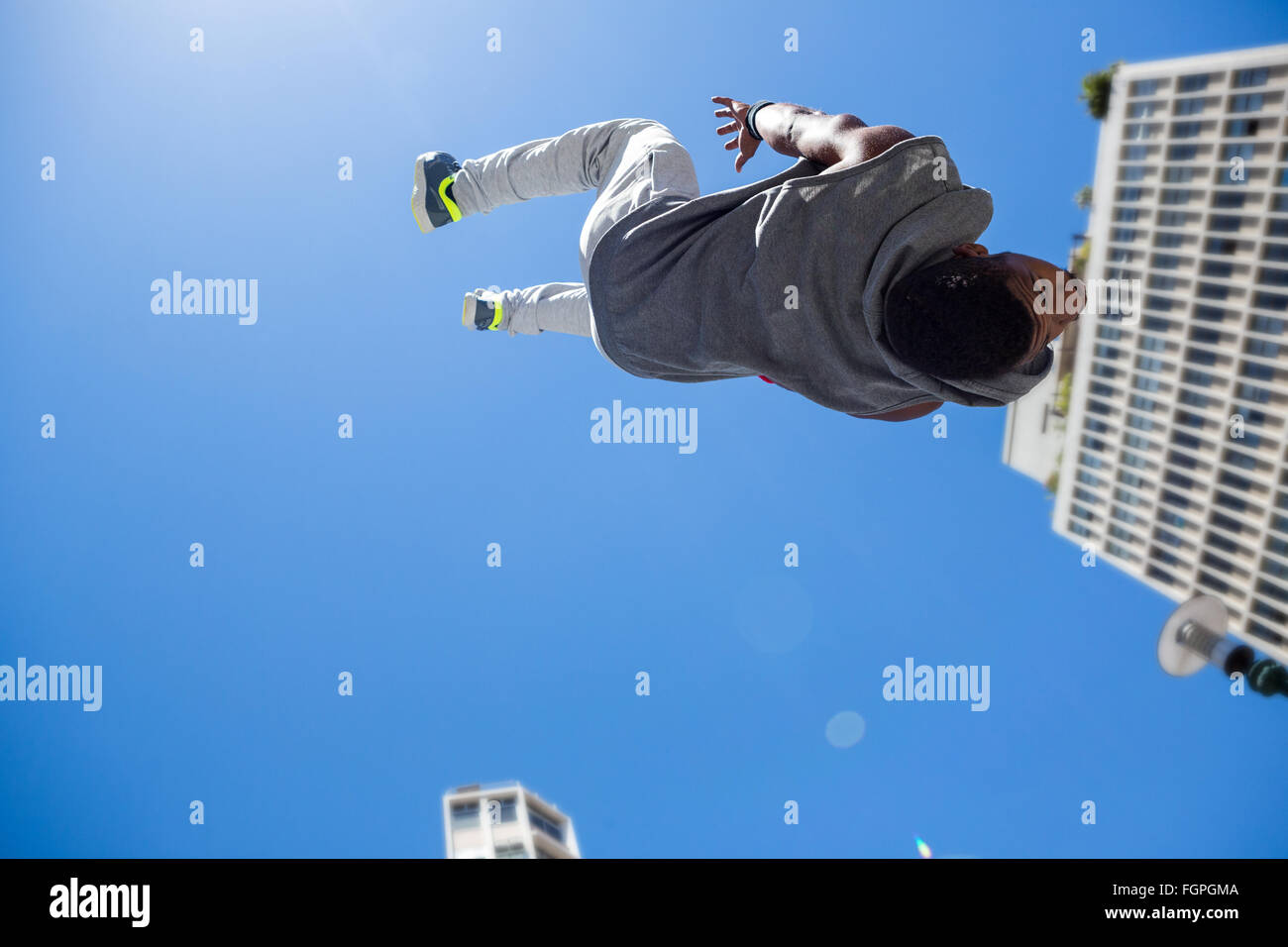 Athletic man doing back flip in the city Stock Photo - Alamy