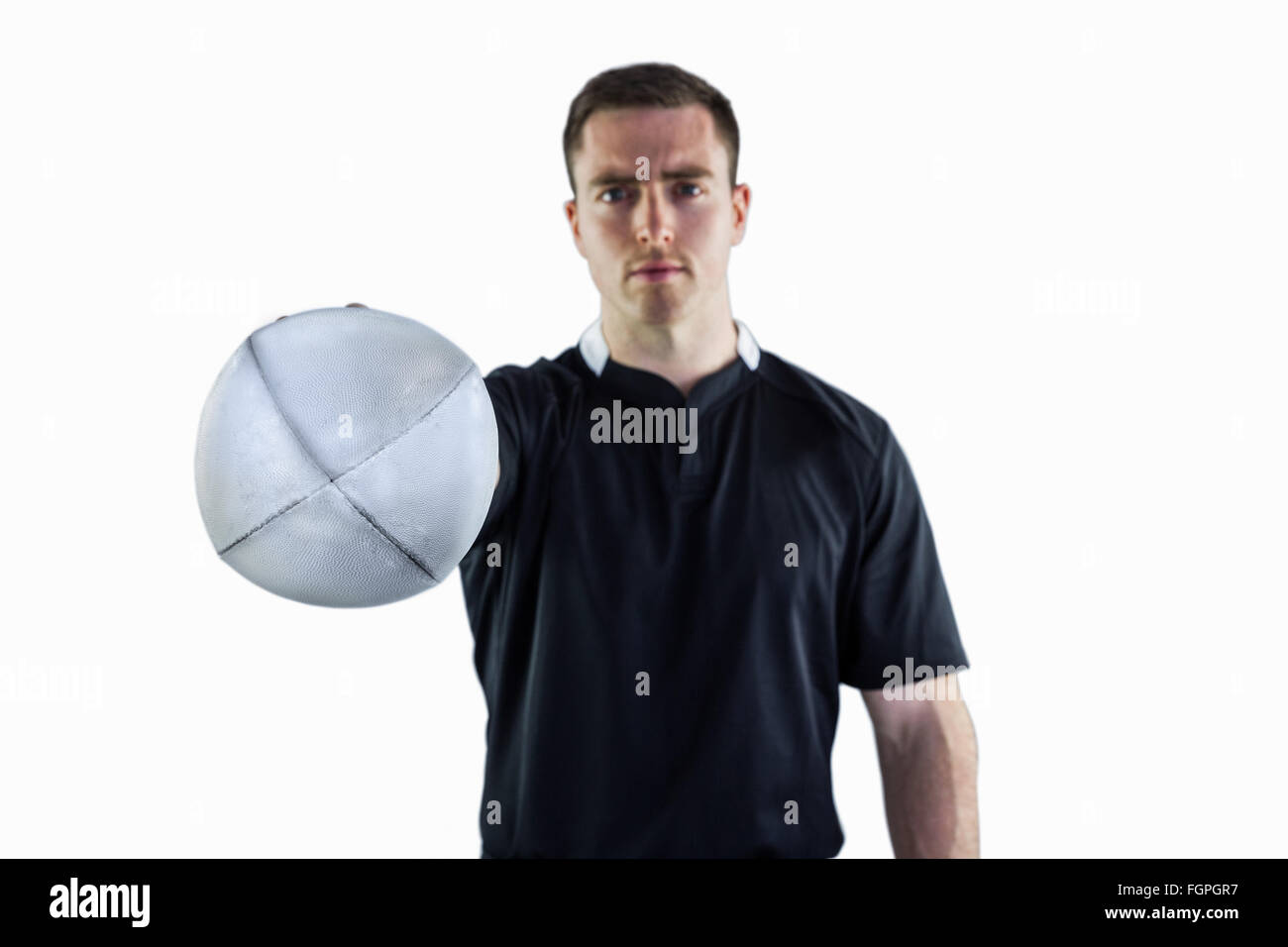 Rugby player handing a rugby ball Stock Photo - Alamy