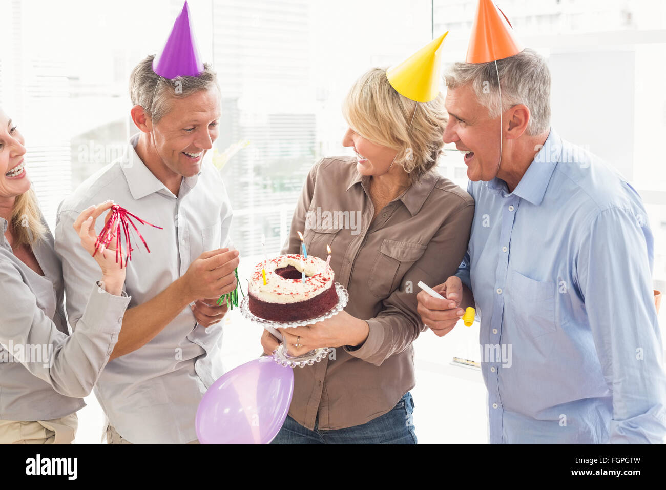 Laughing casual business people celebrating birthday Stock Photo - Alamy