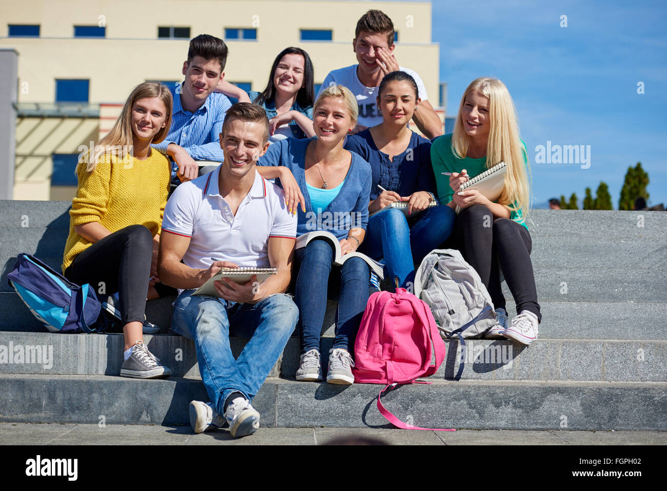 students outside sitting on steps Stock Photo - Alamy