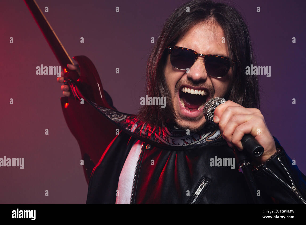 Celebrity holding guitar microphone hi-res stock photography and images ...
