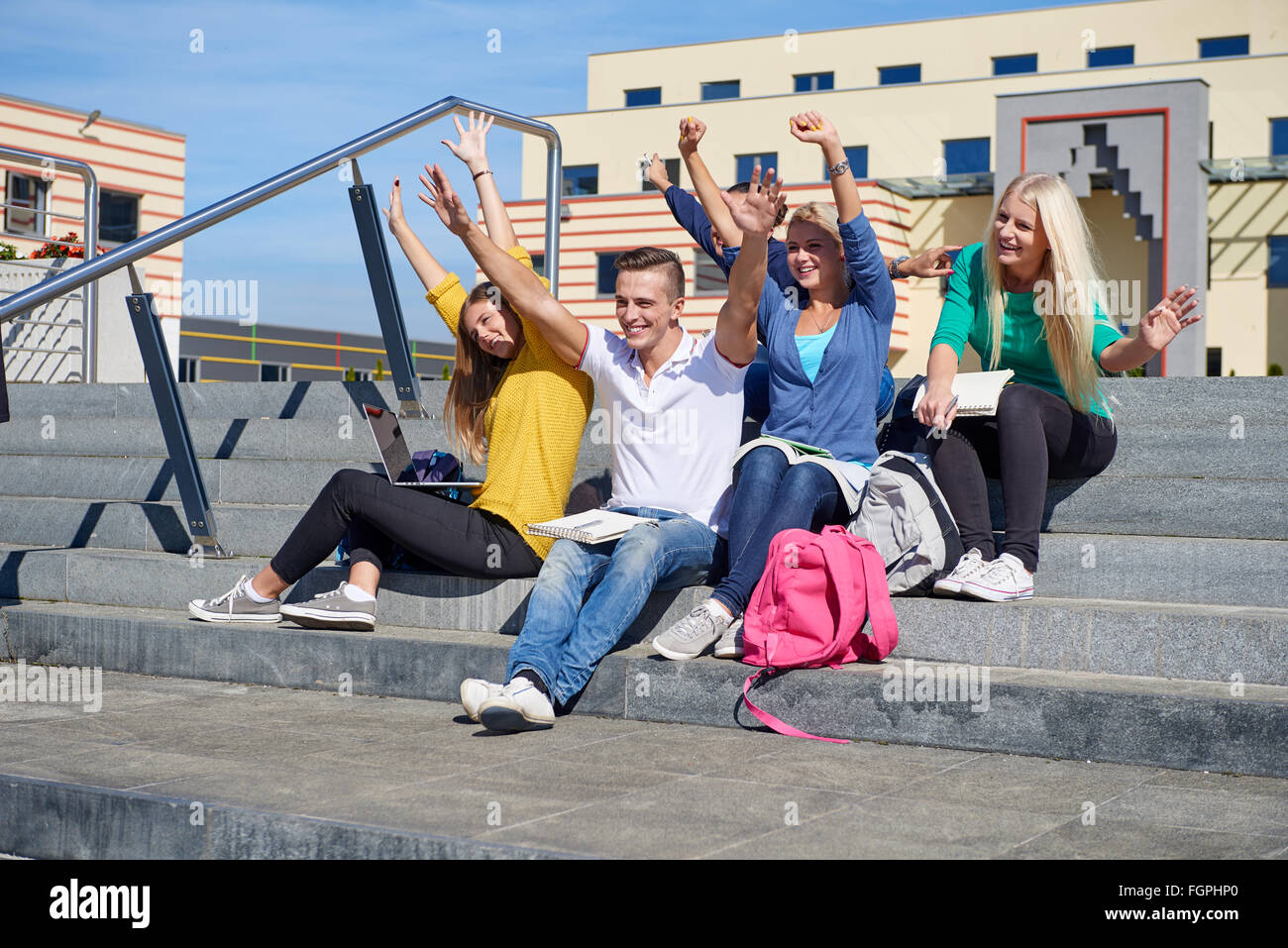 students outside sitting on steps Stock Photo - Alamy