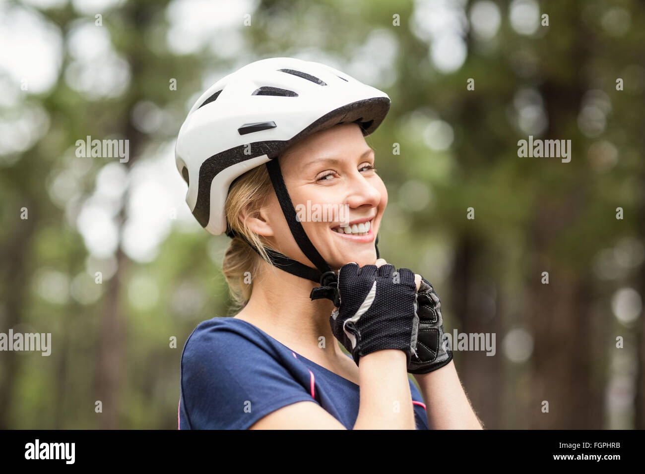Young pretty happy biker taking off helmet Stock Photo - Alamy