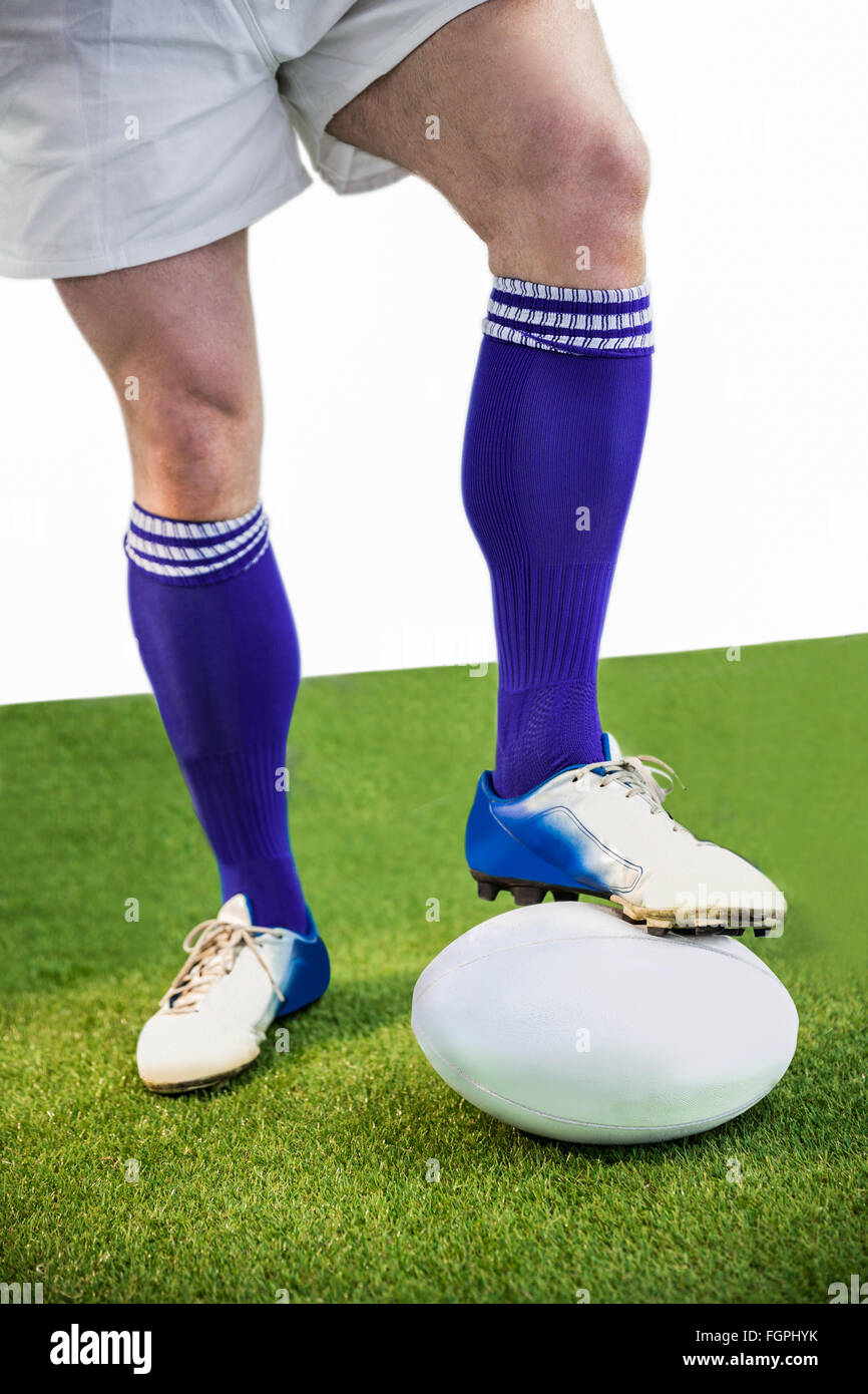 Rugby player posing feet on the ball Stock Photo - Alamy